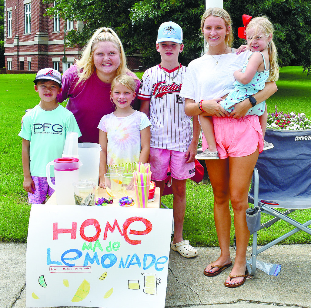The group sold homemade lemonade and bracelets to people walking by ...
